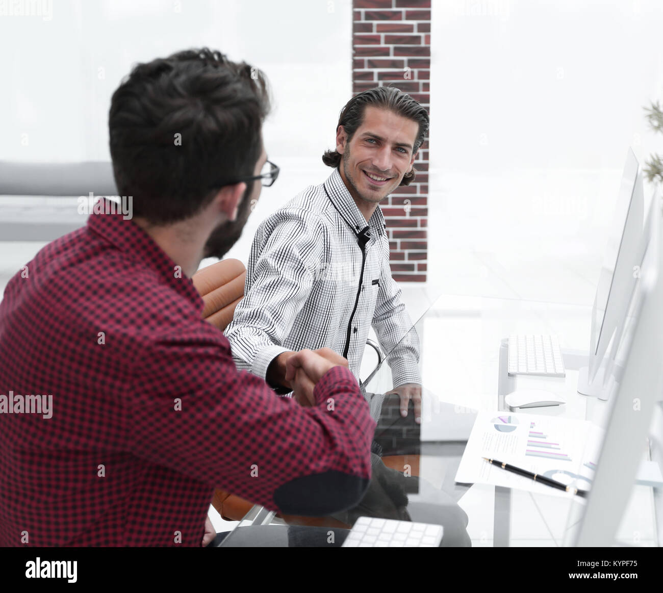 Two men handshake in the office Stock Photo - Alamy