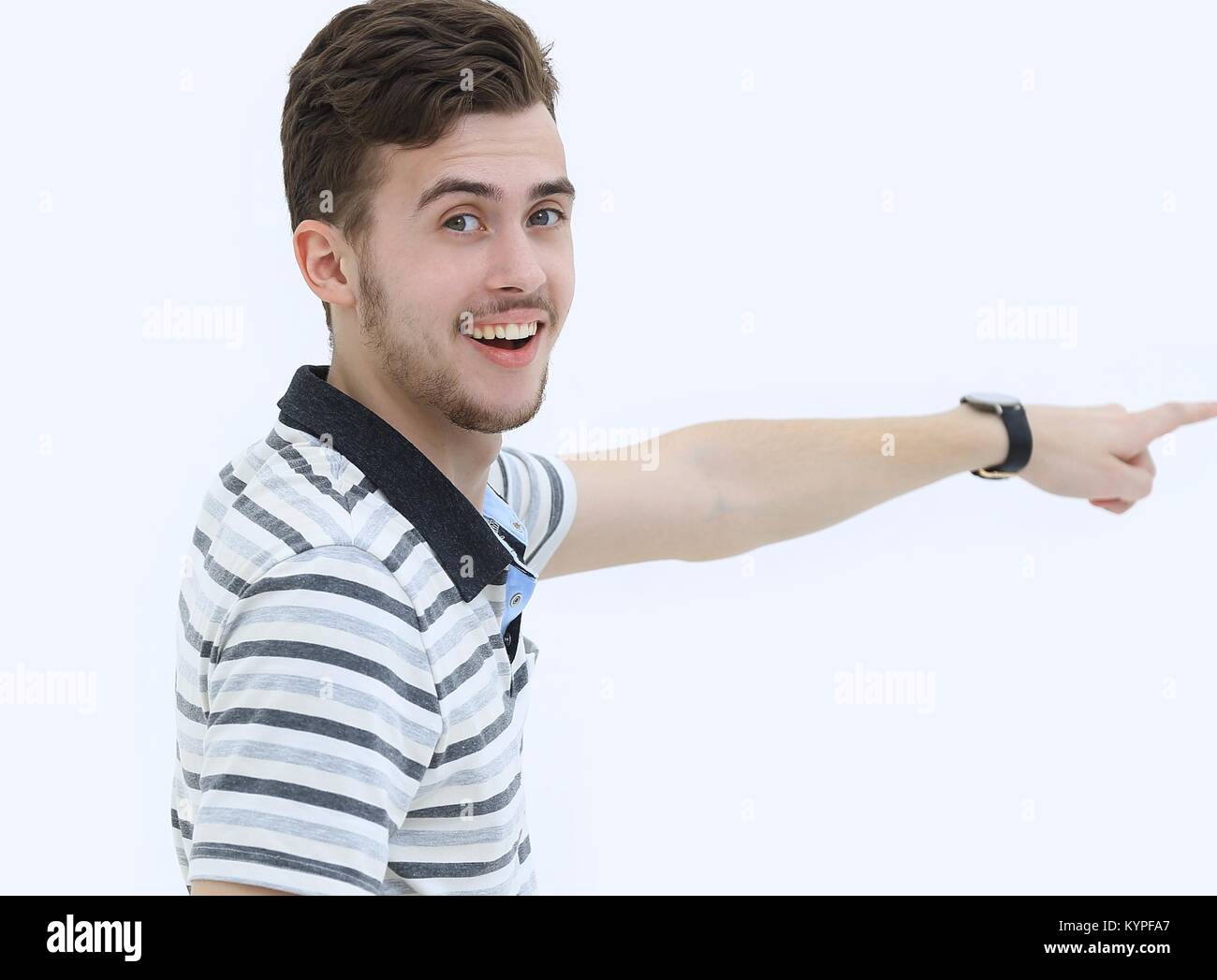 side view.modern young man pointing forward and looking at the camera ...