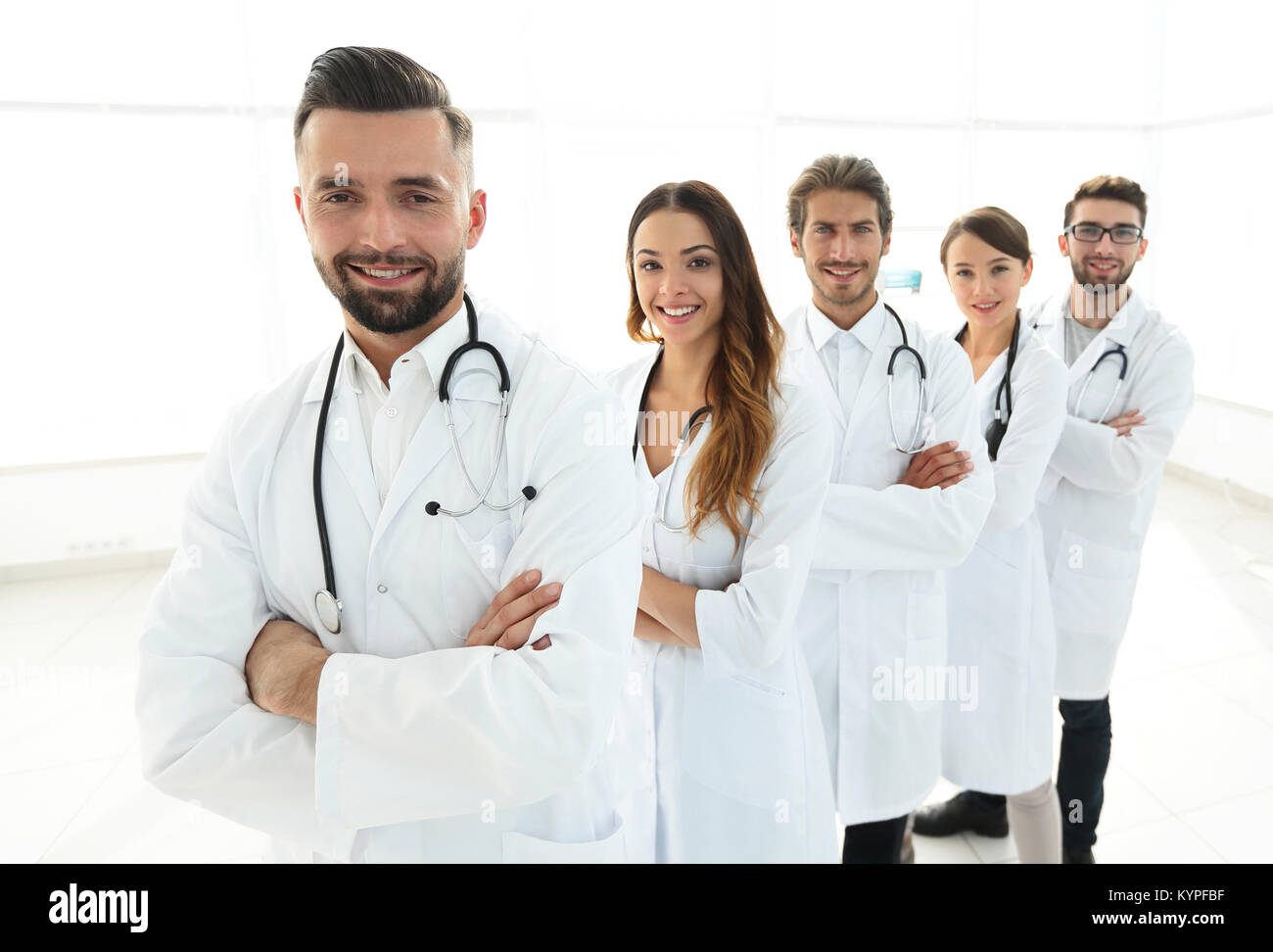 Group of happy successful doctors standing in a row in the hospital ...