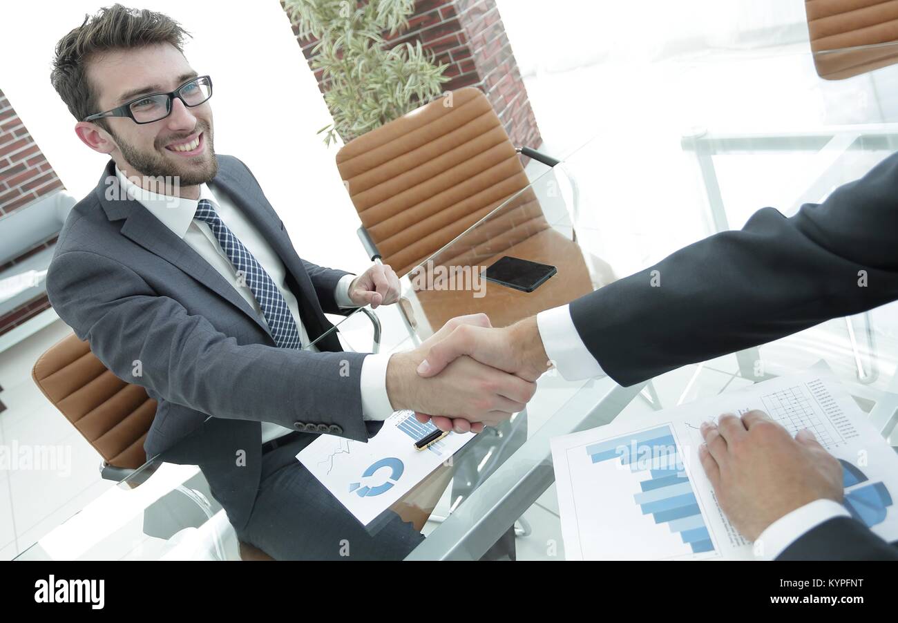handshake business partners at your Desk Stock Photo - Alamy