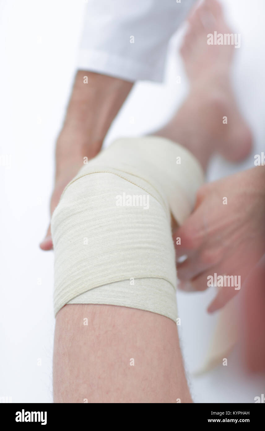 closeup. doctor bandaging a patient's leg Stock Photo - Alamy