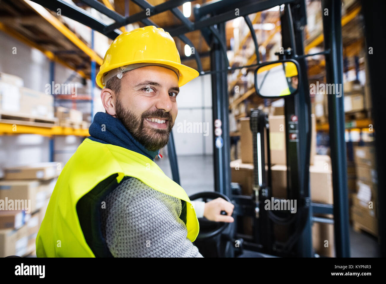 Warehouse man worker with forklift Stock Photo - Alamy