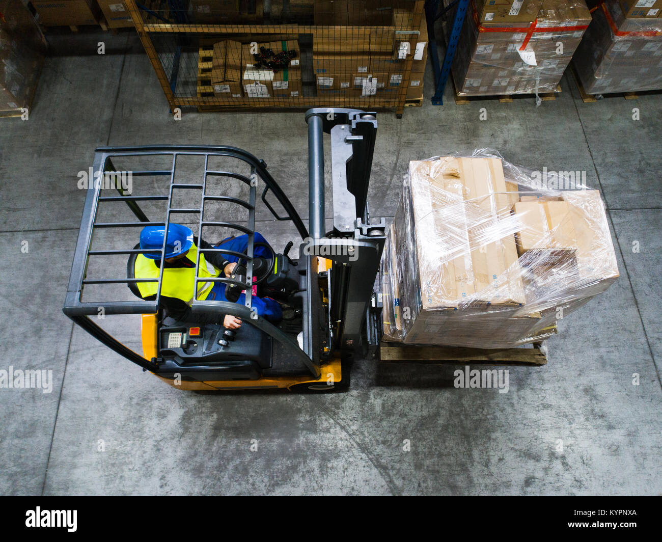 Warehouse man worker with forklift Stock Photo - Alamy