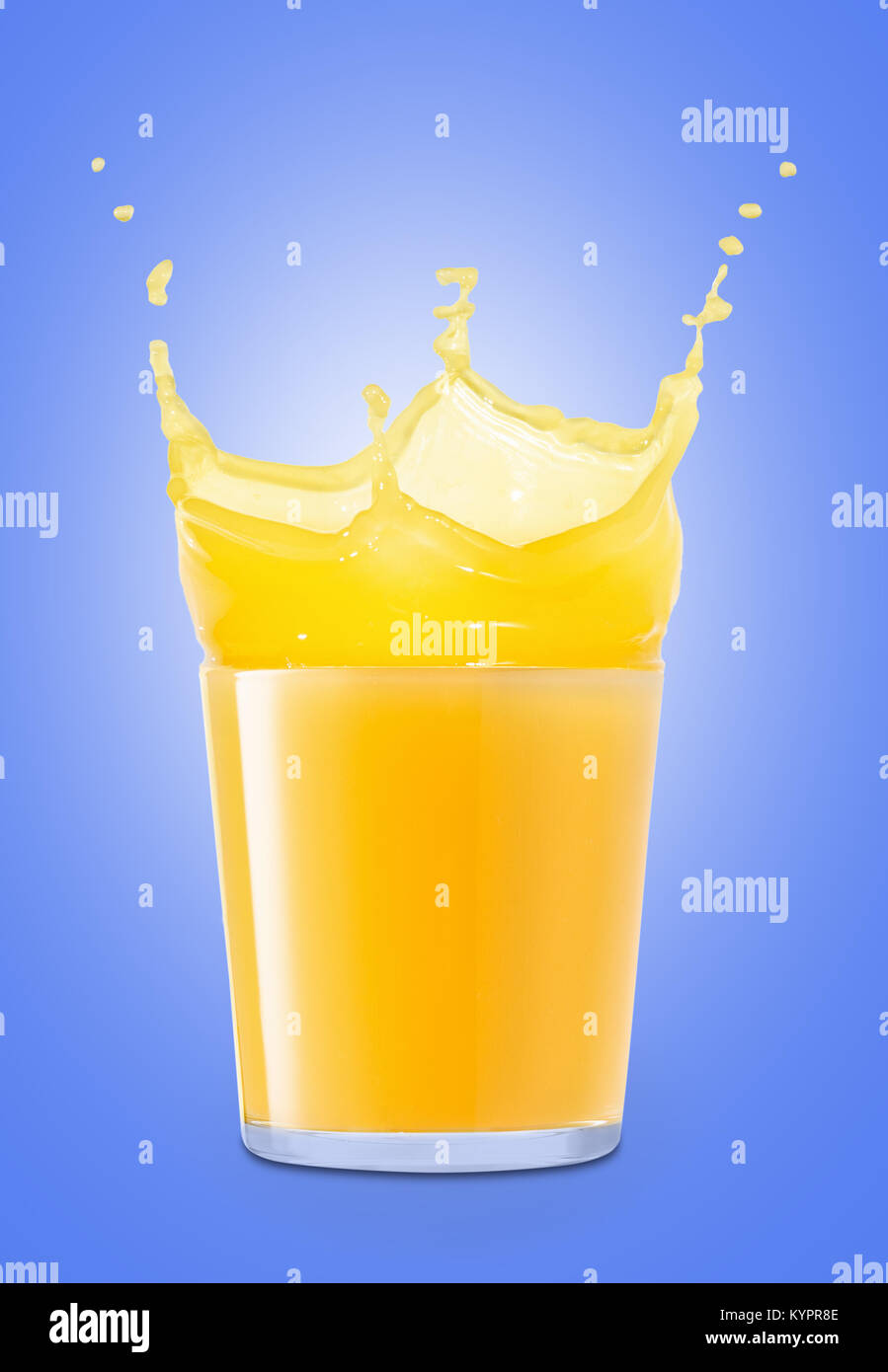 glass of splashing orange juice on blue background. Orange juice splash ...