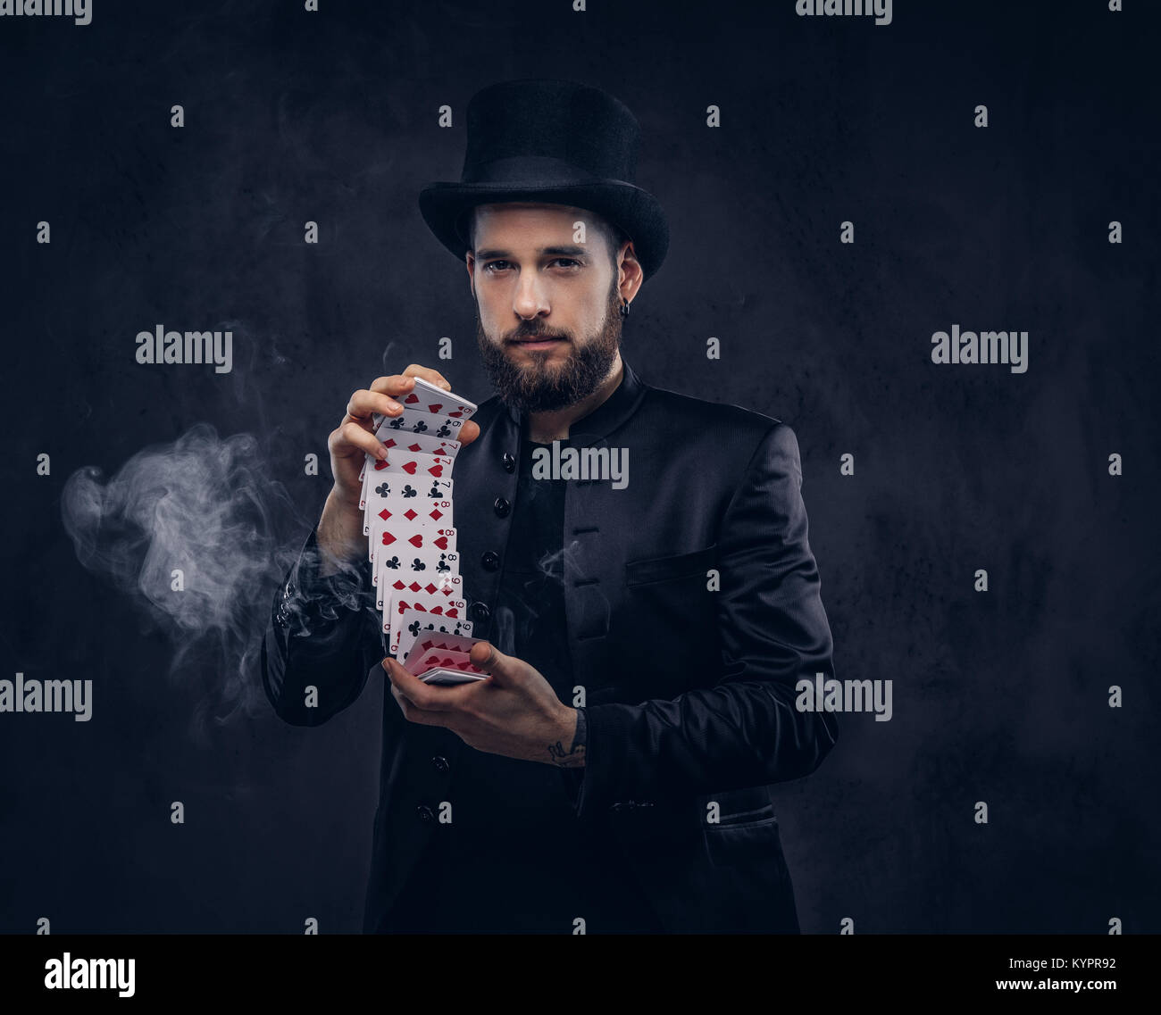Magician showing trick with playing cards Stock Photo - Alamy