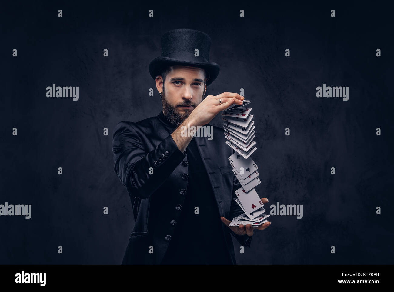 Magician showing trick with playing cards Stock Photo - Alamy