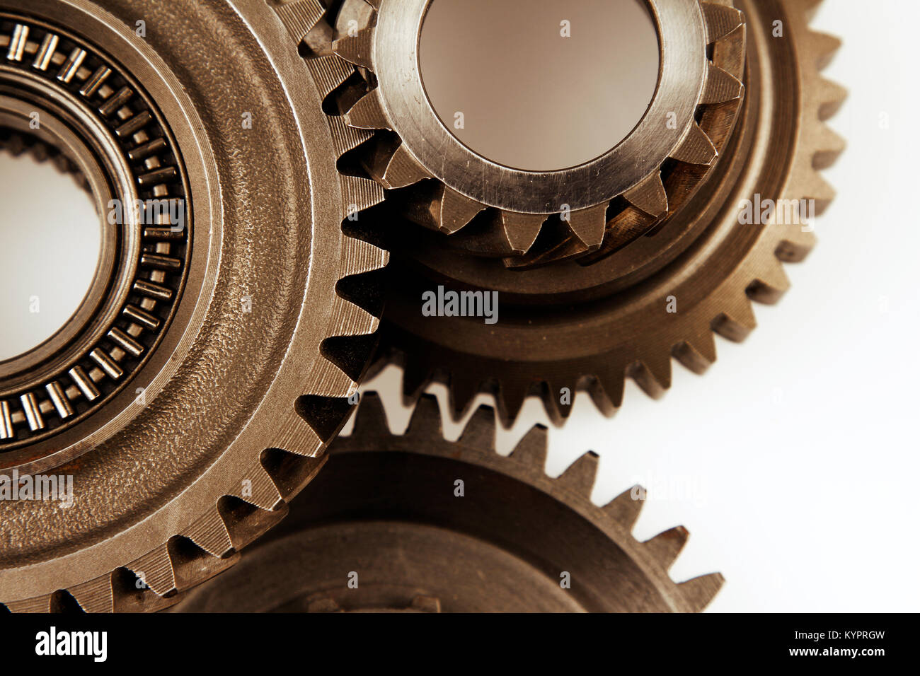 Metal cog gears joining together Stock Photo - Alamy