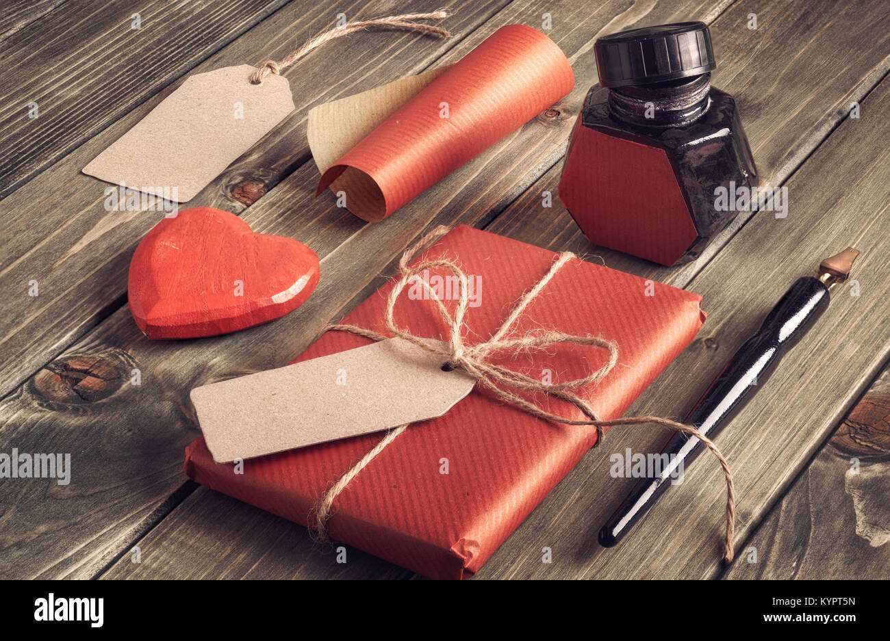Packed present, wrapping paper, labels, ink well, pens and decorative ...