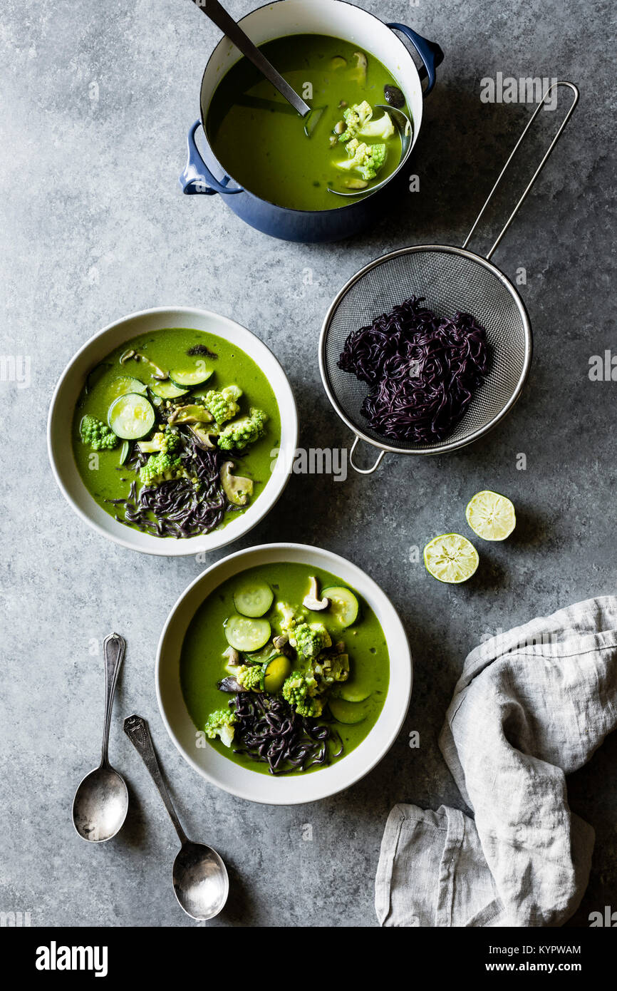 Green thai vegetable soup with cilantro and black rice noodles Stock ...