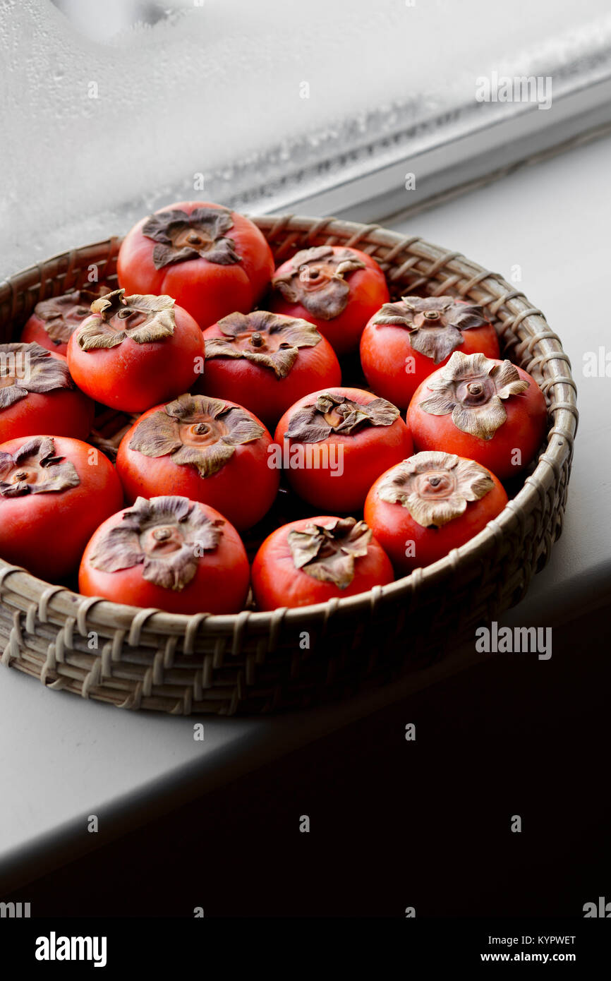 Basket of persimmons hi-res stock photography and images - Alamy