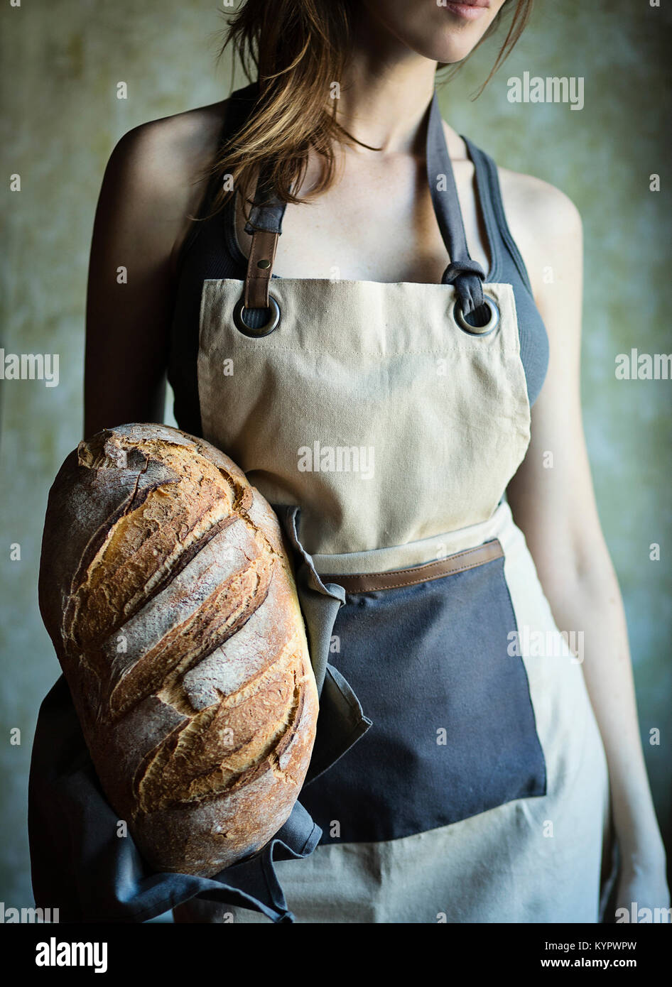 Young woman holding in her hand a fresh loaf of italian bread Stock ...