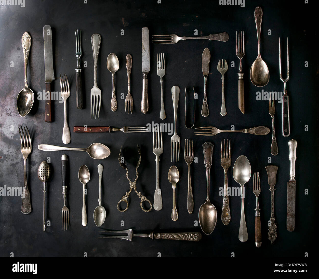 Big set of vintage cutlery over black metal background. Top view Stock ...