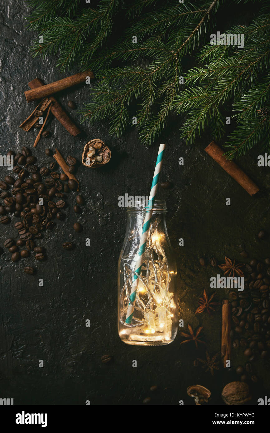 Christmas lights garland in glass bottle with coffee beans, spices ...