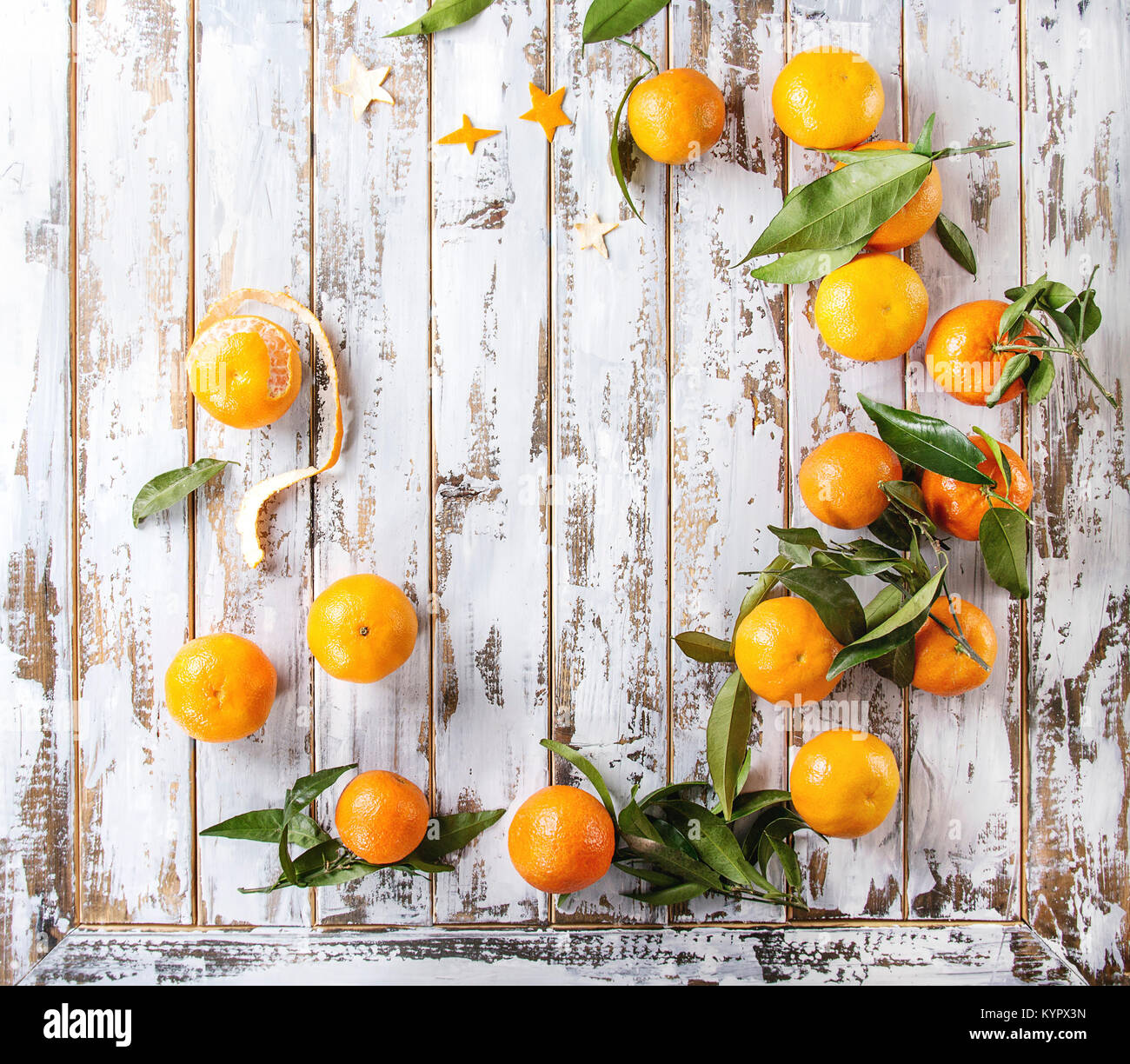 Clementines tangerines with leaves as Christmas decor over white wooden ...