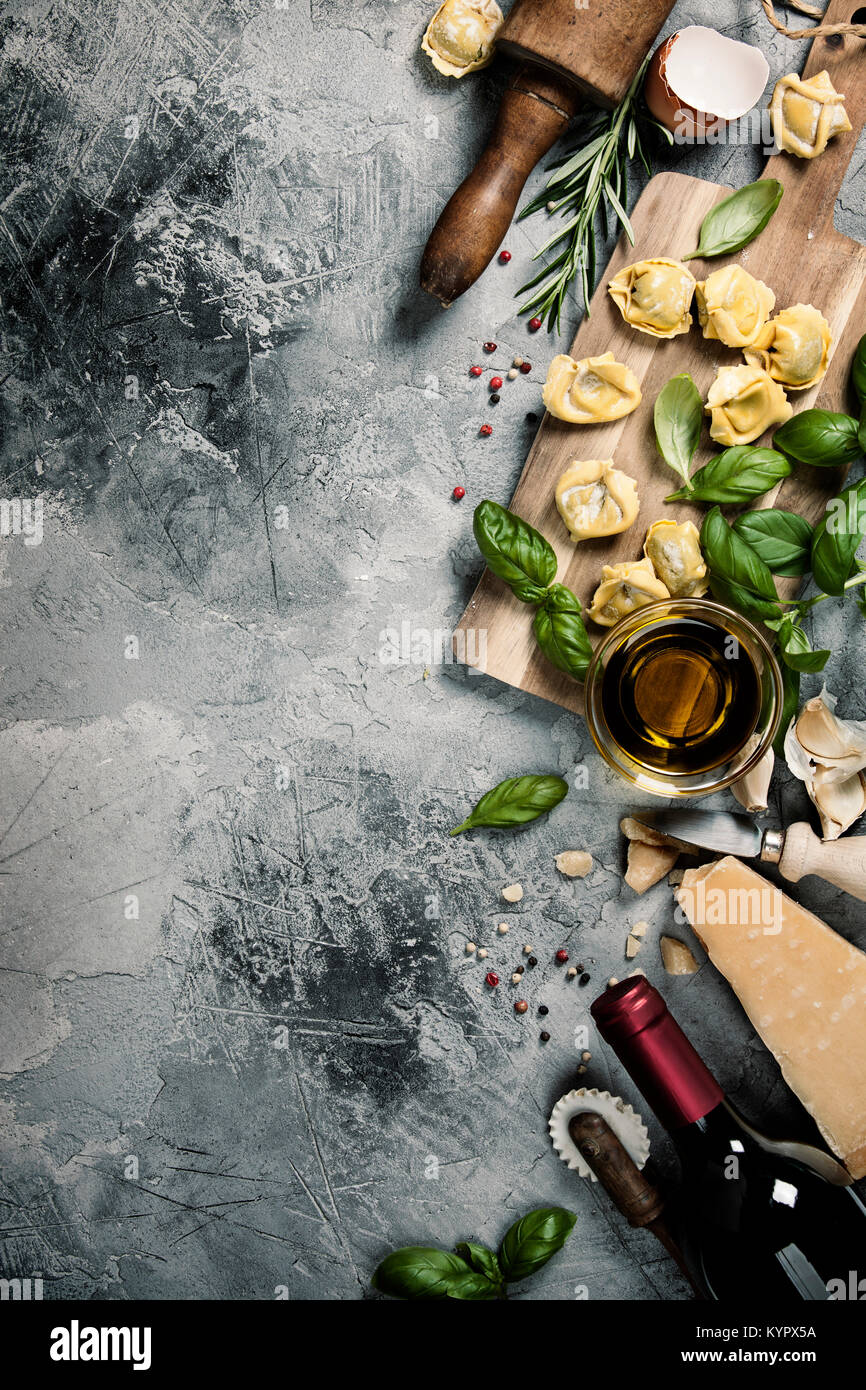 Italian food background with ravioli, vine tomatoes, basil, spaghetti ...
