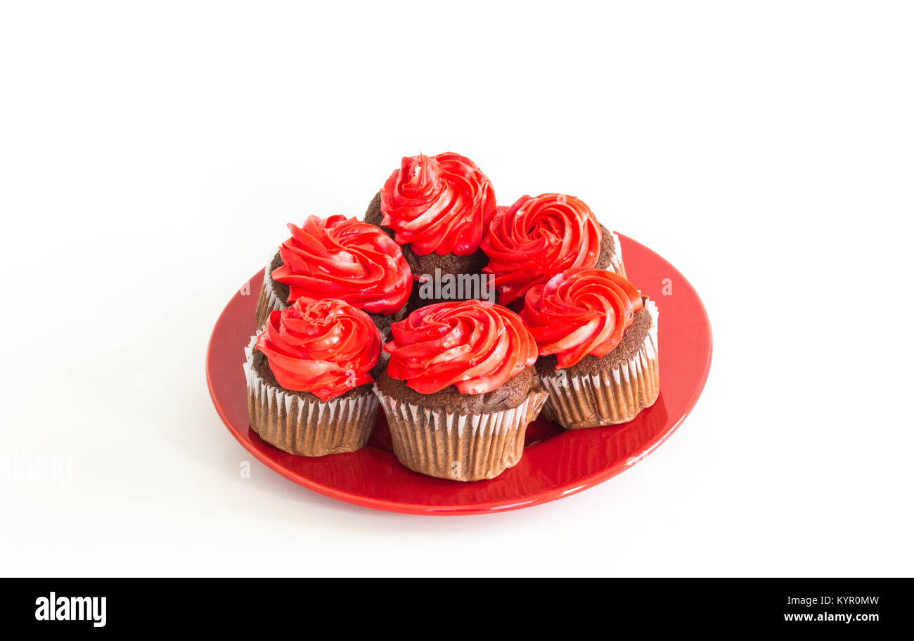 6 kosher chocolate cupcakes with red frosting on a red plate isolated ...