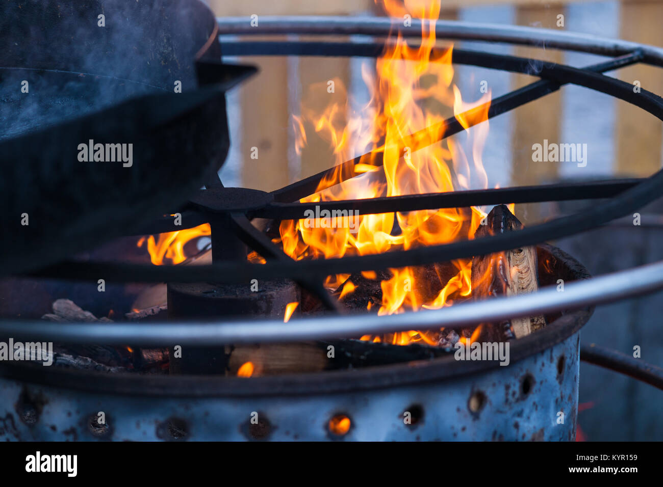 Metal stove with open fire to prepare some food outdoor. Nobody around ...