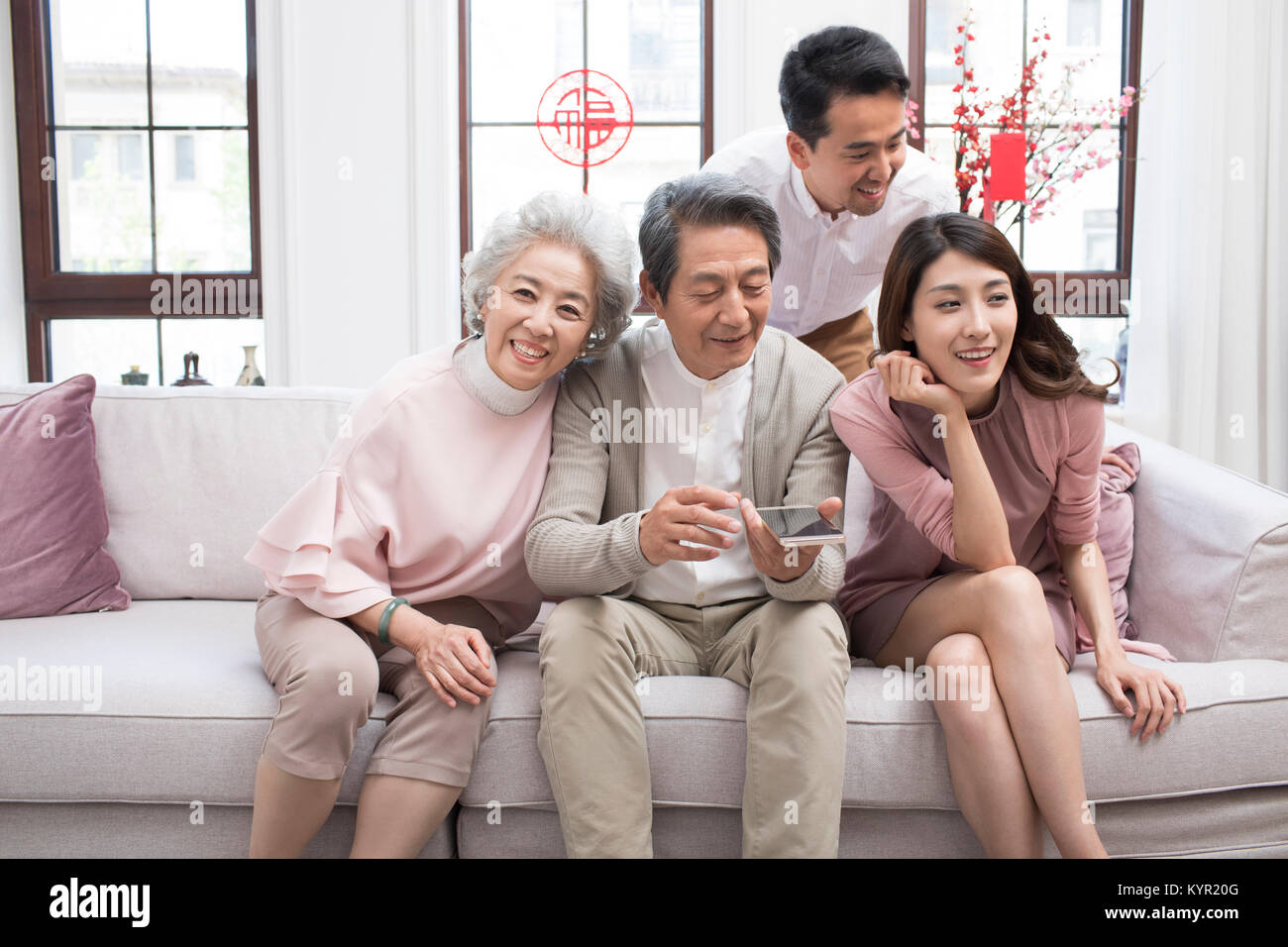 Happy family talking on the phone during Chinese New Year Stock Photo ...