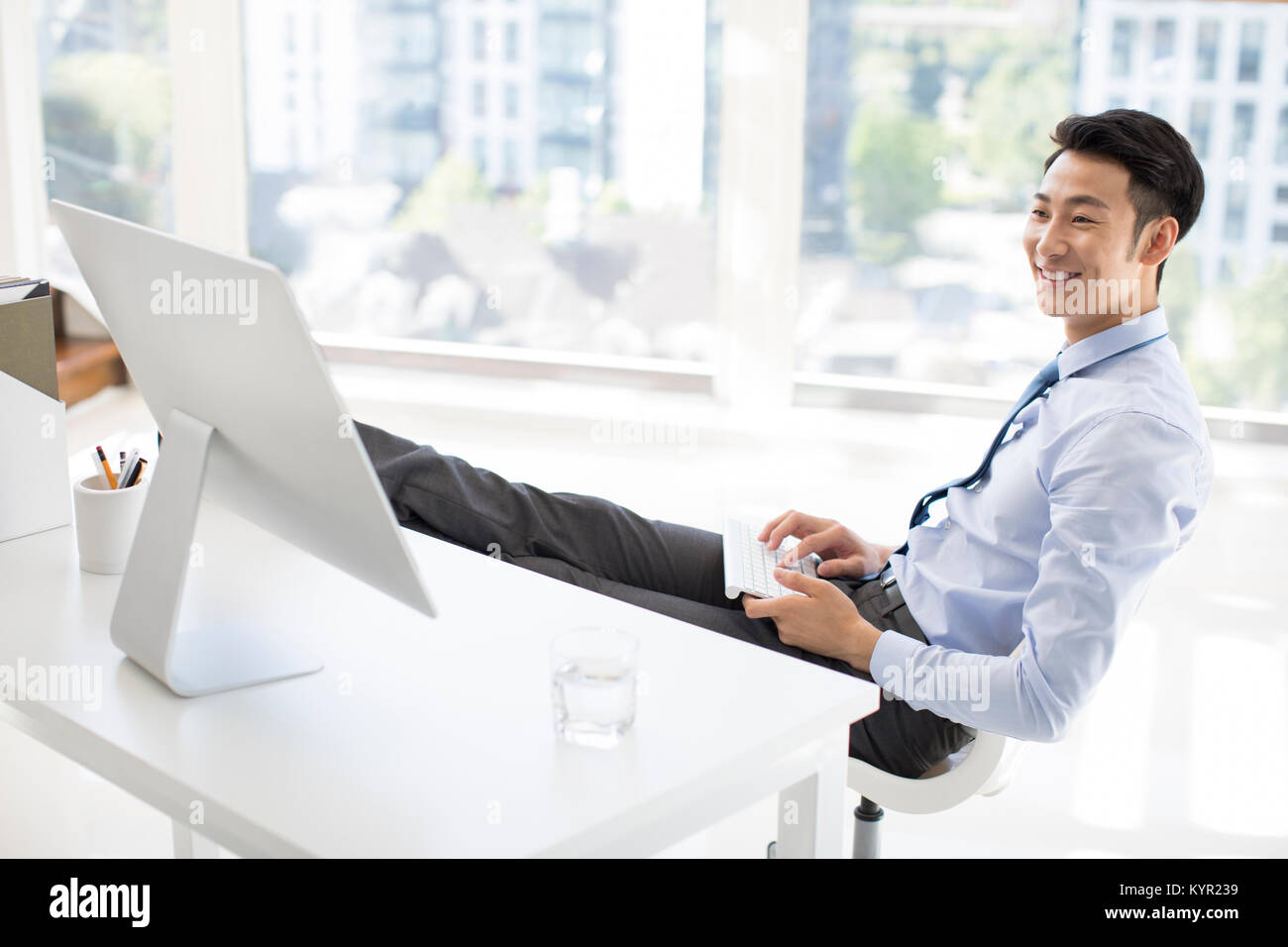 Young businessman using computer in office Stock Photo - Alamy