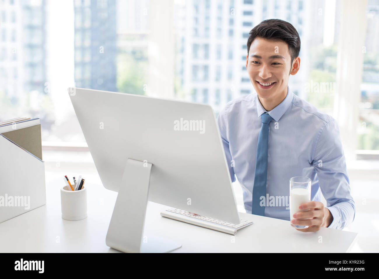 Young businessman using computer in office Stock Photo - Alamy