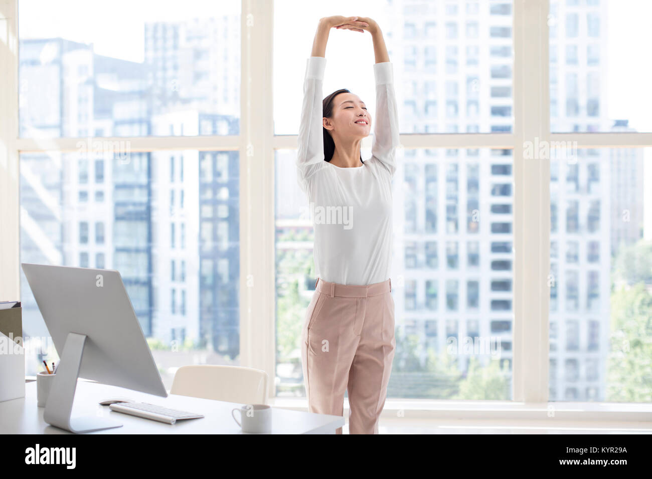 Young businesswoman stretching in hi-res stock photography and images ...