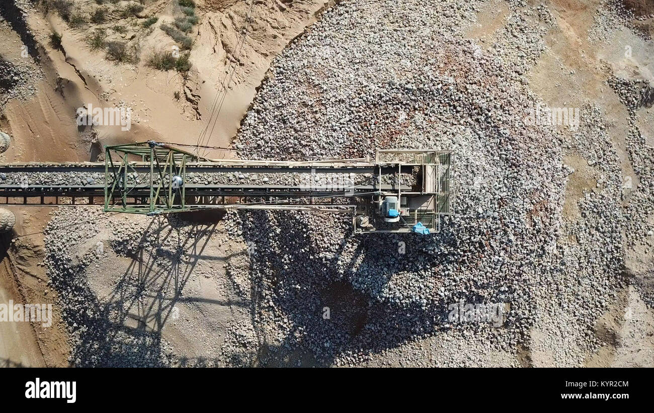 Stone sorting conveyor belt in a large Quarry - Top down aerial view ...