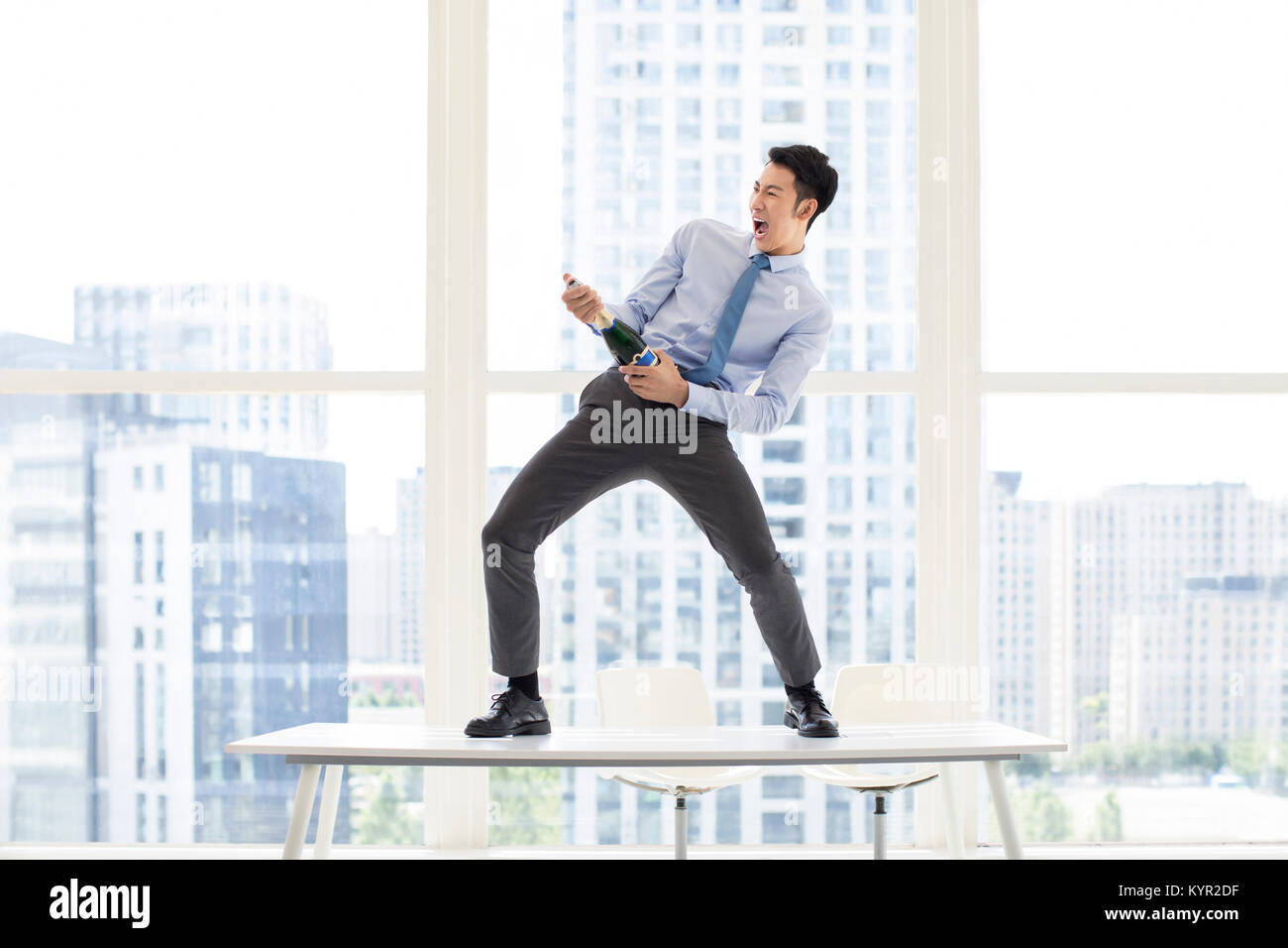 Cheerful businessman cheering with champagne bottle Stock Photo - Alamy Cheerful businessman cheering with champagne bottle Stock Photo - Alamy