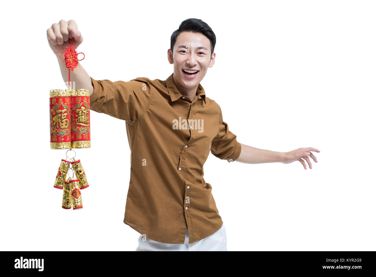 Cheerful young man with firecracker celebrating Chinese New Year Stock ...