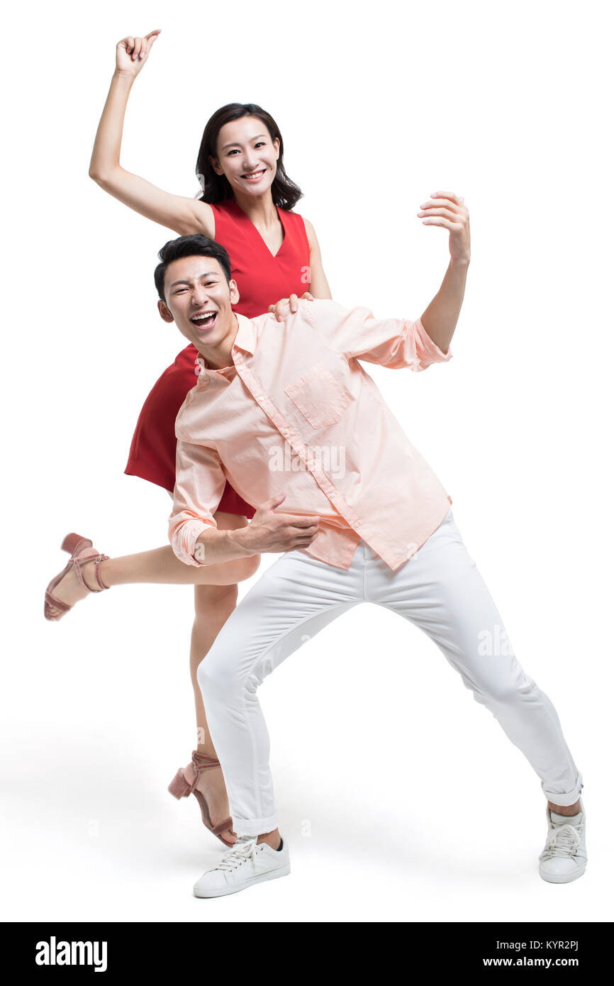 Cheerful young couple dancing Stock Photo - Alamy