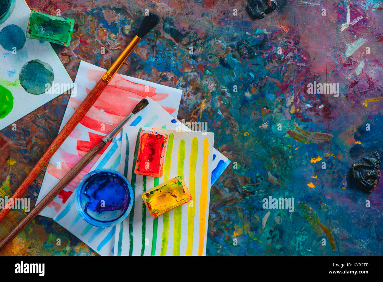 Header with brushes, watercolor paints and sketches. Artist tools on a ...