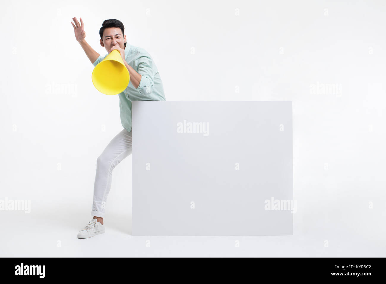 Young man shouting through megaphone Stock Photo - Alamy