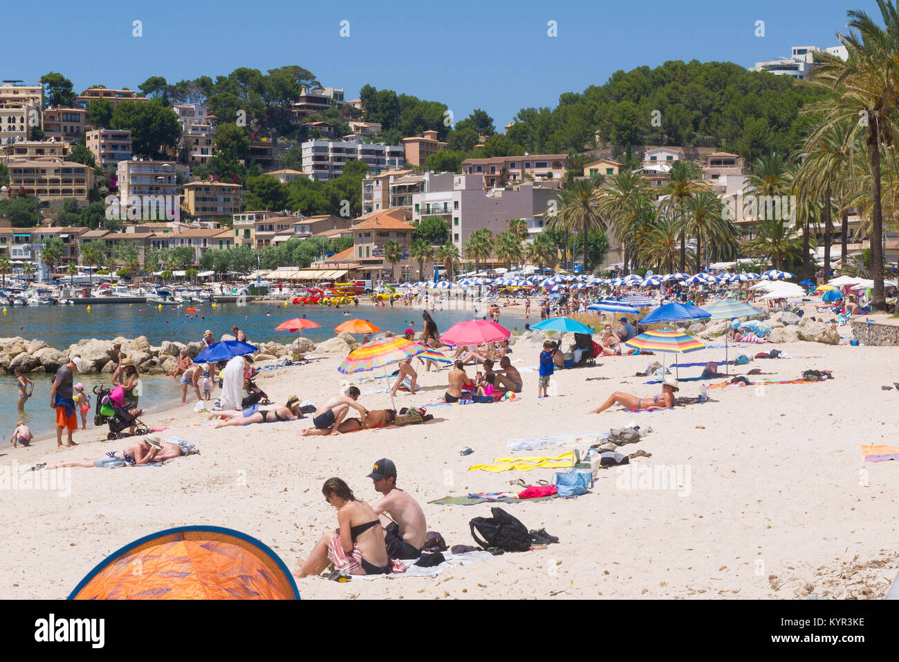 People relaxing on the beach on a warm summer`s day in Port De Soller ...