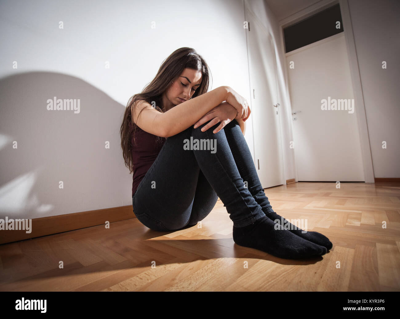 Teen girl sitting in empty room hi-res stock photography and images - Alamy