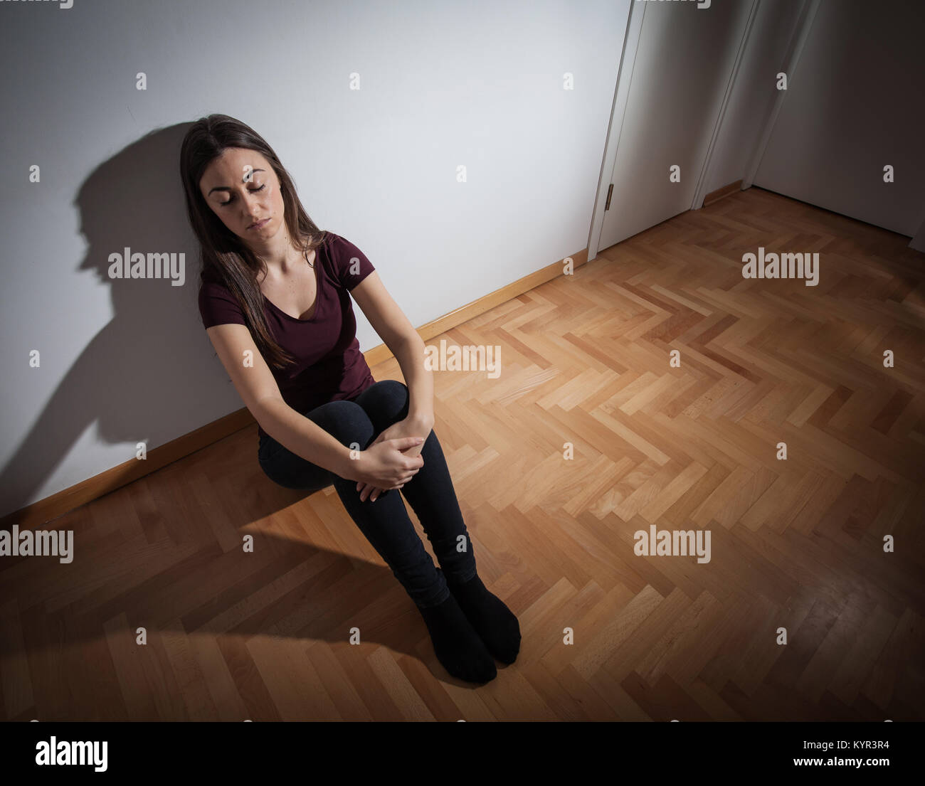 Teen girl sitting in empty room hi-res stock photography and images - Alamy