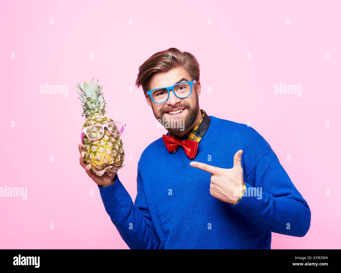 Funny man posing with pineapple Stock Photo - Alamy