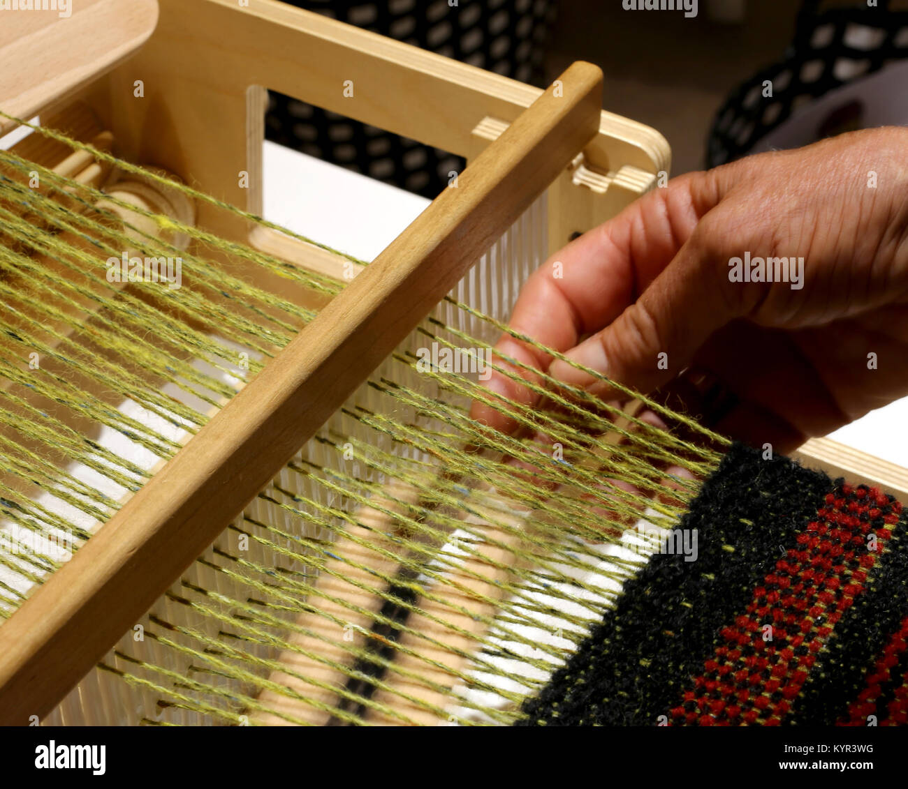 hand of the old woman during the processing of the fabric in the ...