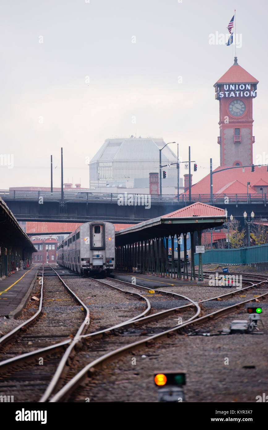 Passenger train stands on the curved railroad at historic railway ...