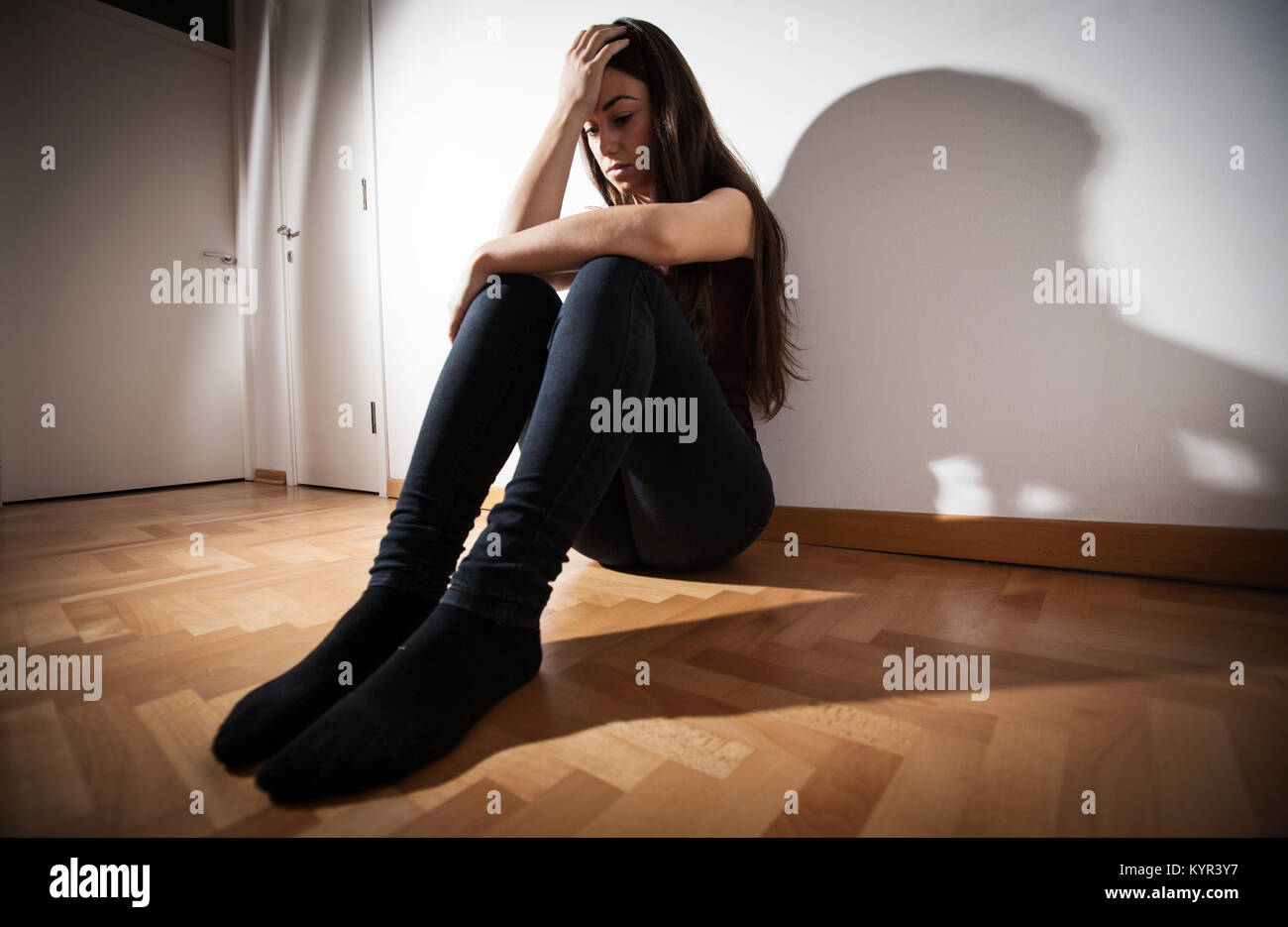Teen girl sitting in empty room hi-res stock photography and images - Alamy