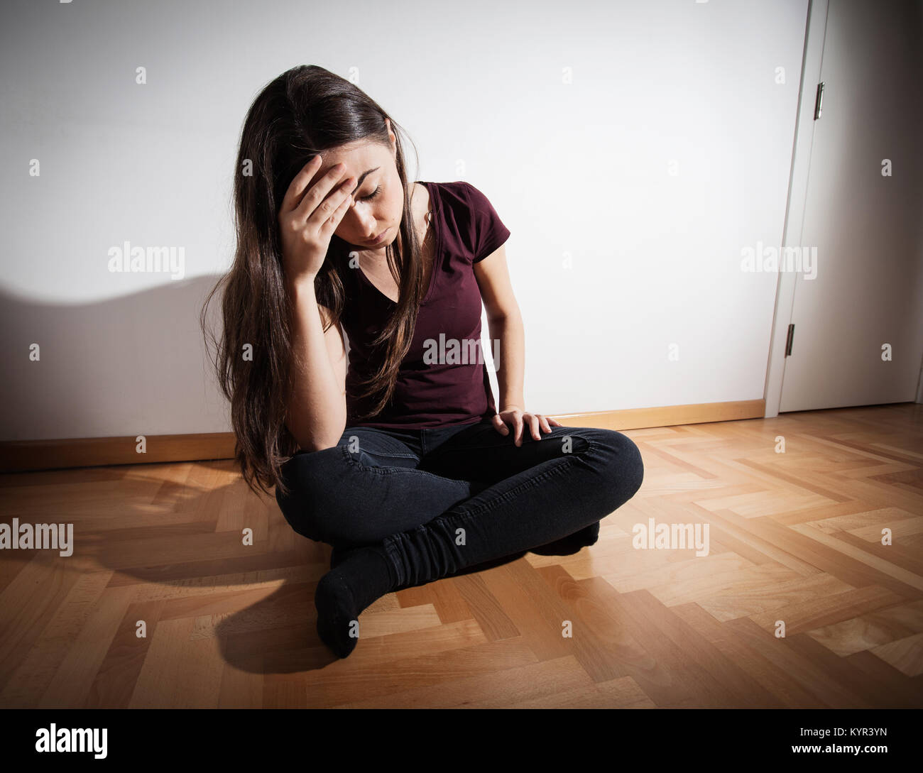 Depressed woman sitting on floor in empty room, female suffering from ...