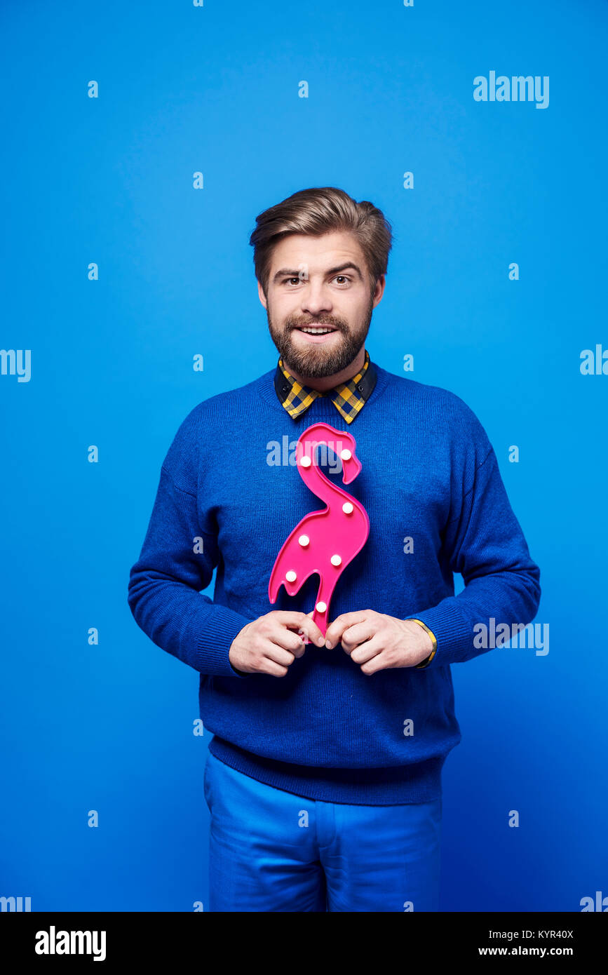 Man with artificial flamingo at studio shot Stock Photo - Alamy