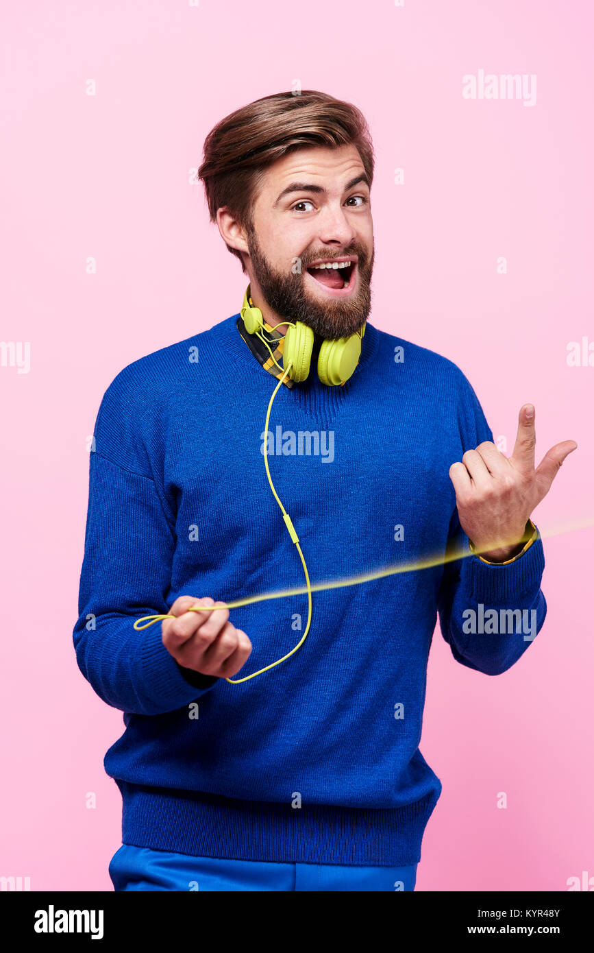 Cheerful man with headphones around his neck Stock Photo - Alamy