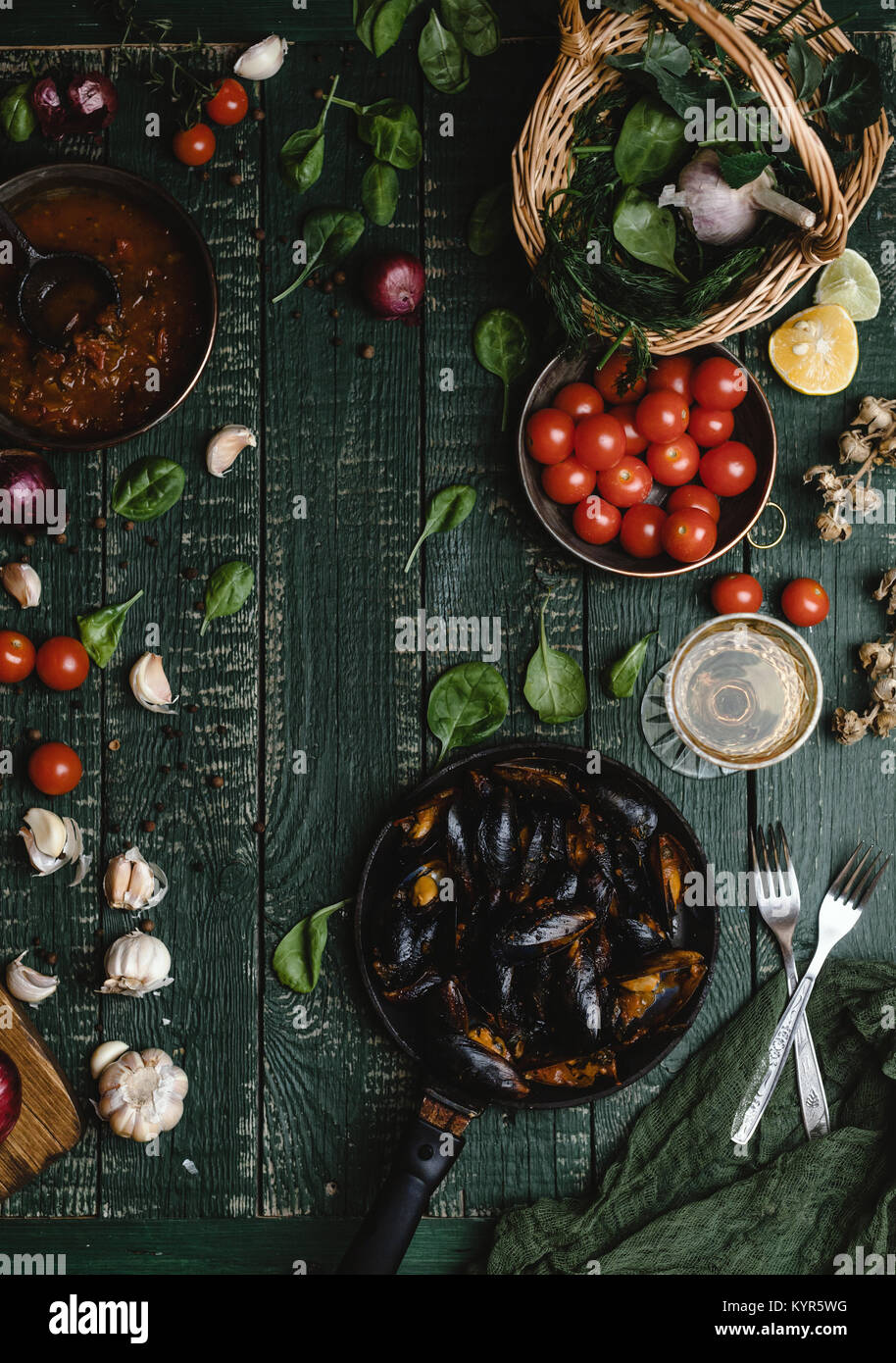 Top view of cooked mussels with shells served in pan with tomatoes ...