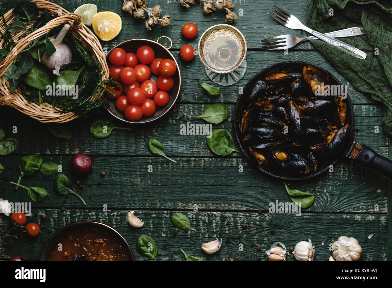 Top view of cooked mussels with shells served in pan with tomatoes ...