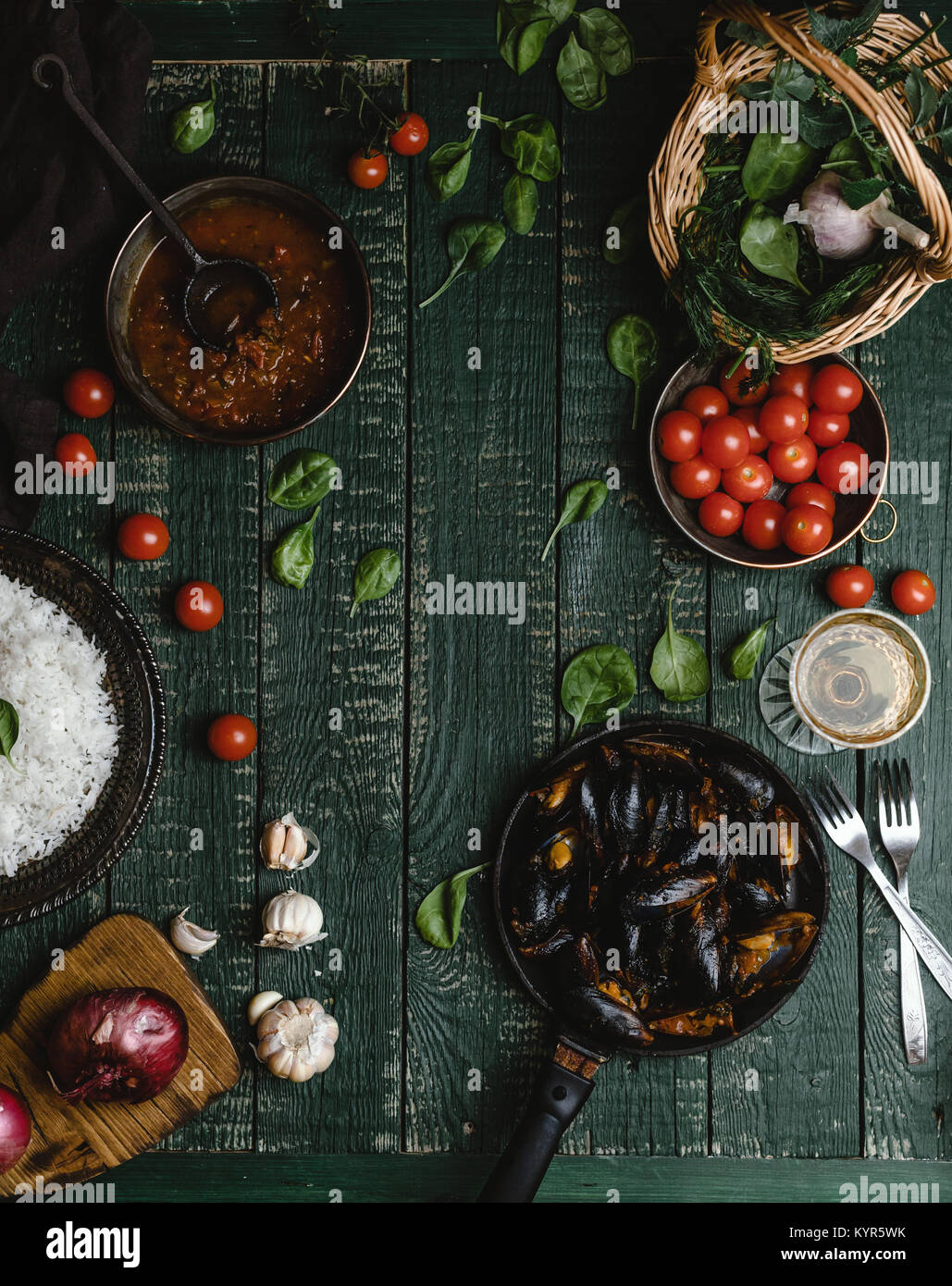 Top view of cooked mussels with shells served in pan with tomatoes ...