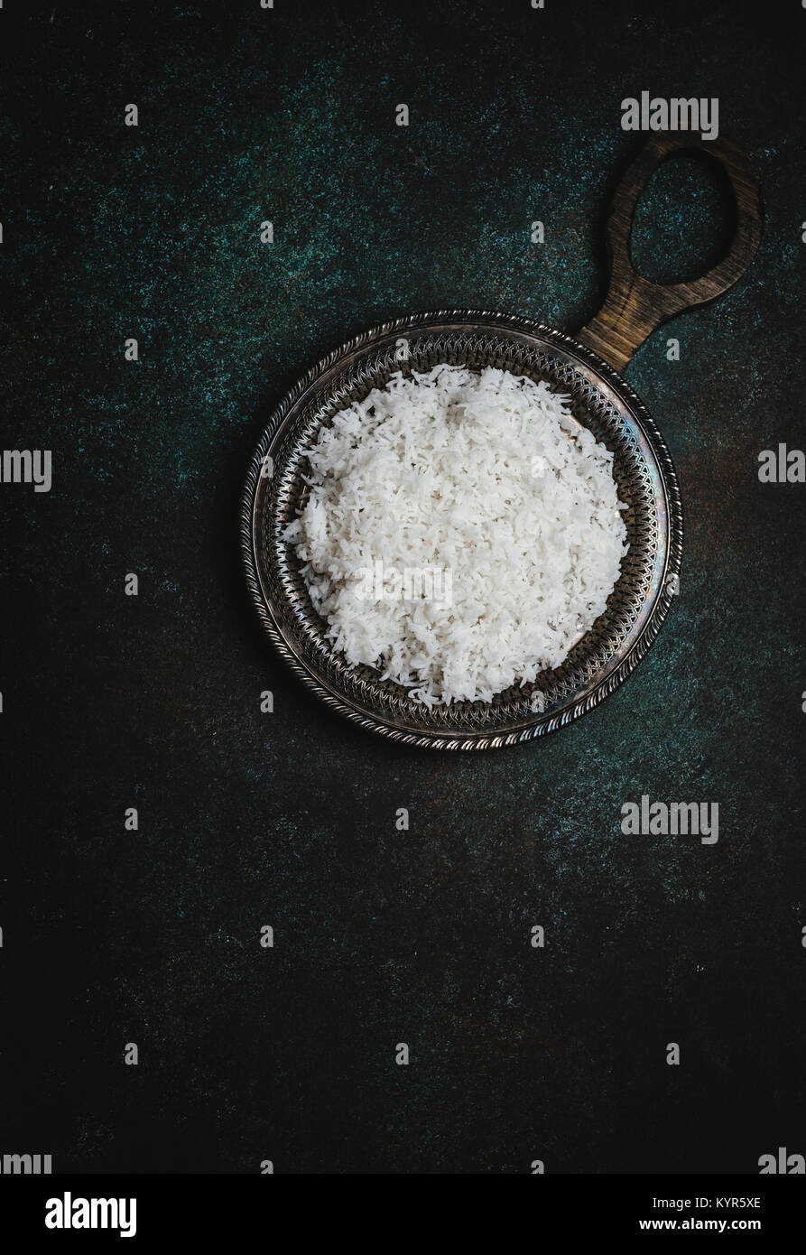Top view of cooked white rice on rustic metal tray on dark table Stock ...