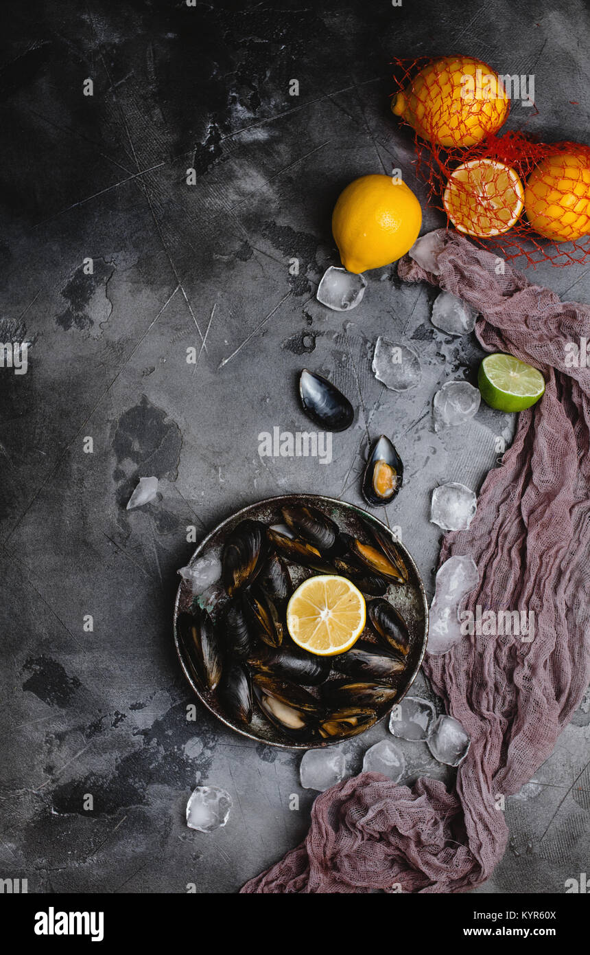top view of delicious mussels with shells on vintage plate and citrus ...