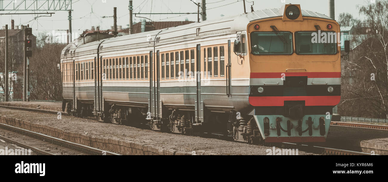 Old yellow passenger diesel train moving at the terminal Stock Photo ...