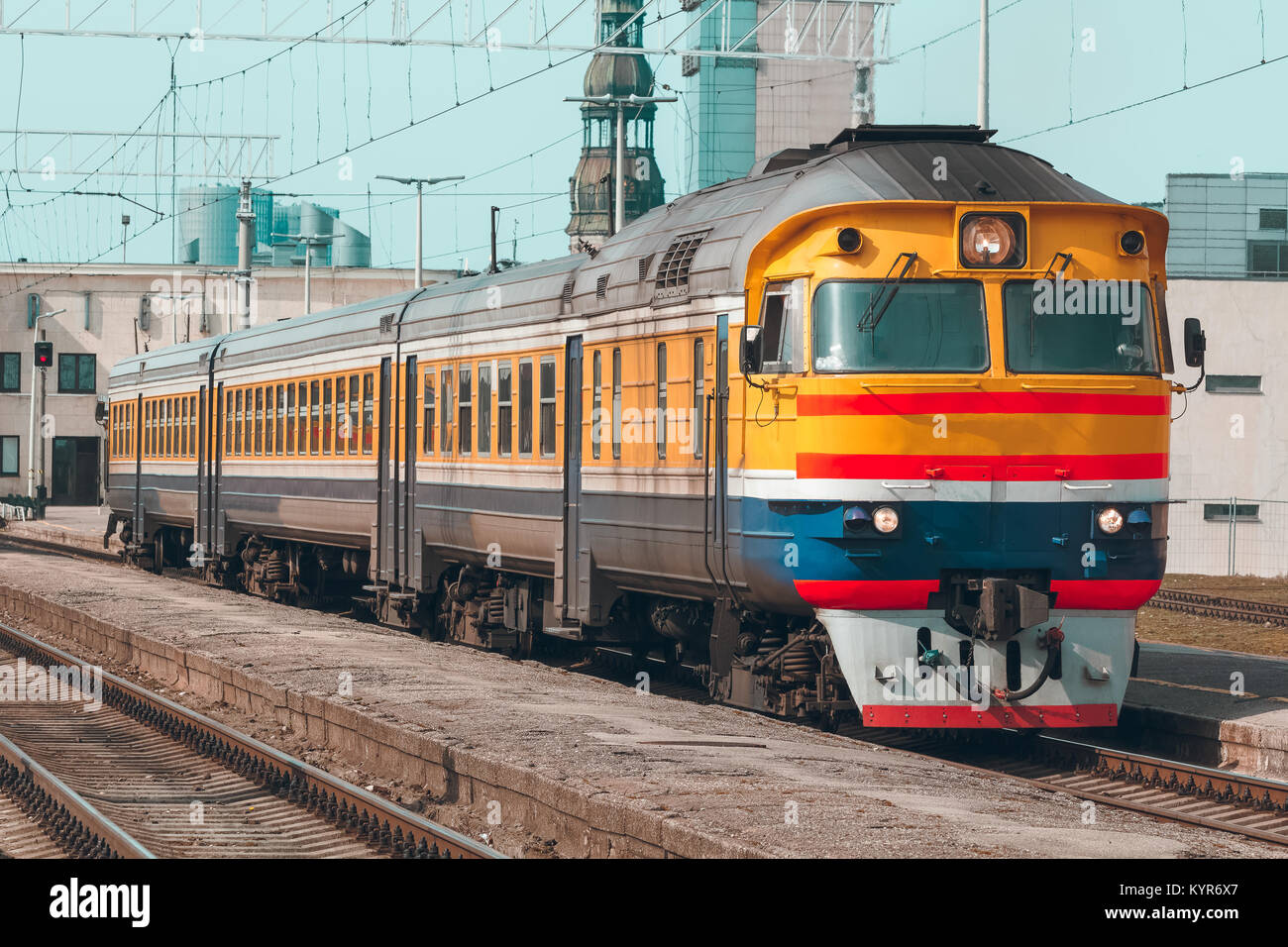 Old yellow passenger diesel train moving at the terminal Stock Photo ...