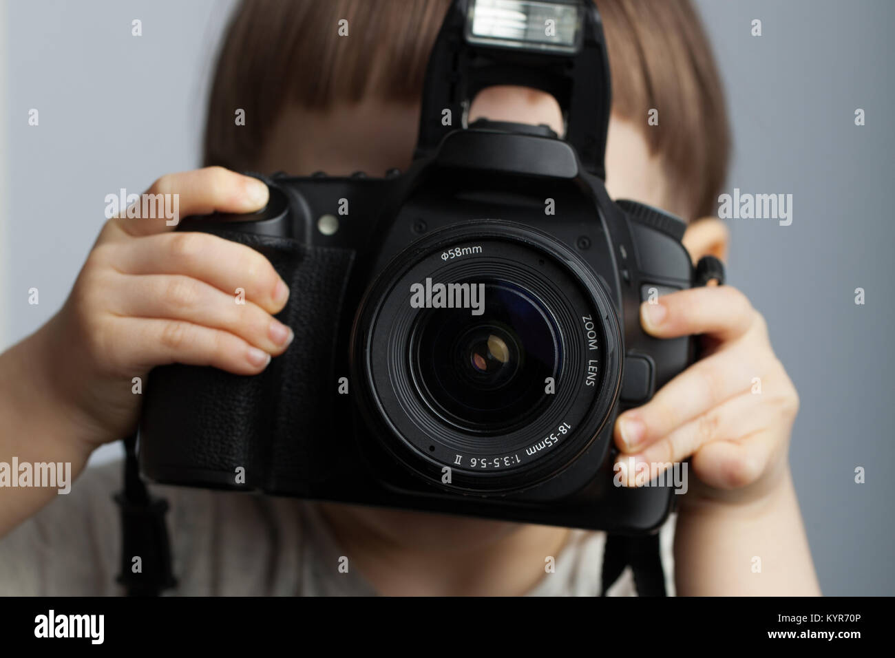 Beautiful child in with professional camera. Little boy with long blond ...