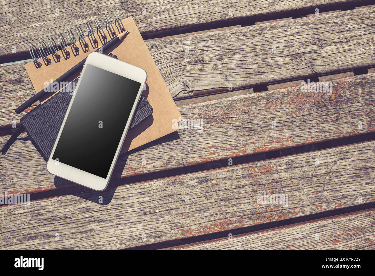 White smartphone and notebooks on wooden background Stock Photo - Alamy